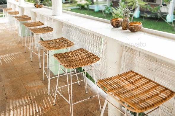 Wicker rattan chairs on bar counter. Trendy furniture design. Summer ...