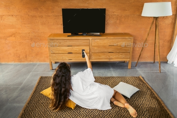 Entertainment at home, tv addiction. Stay home. Woman switch channels ...