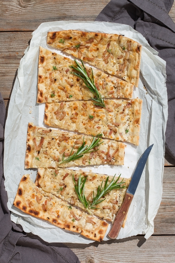 Flammkuchen, traditional German pizza with red onion, bacon, cream ...