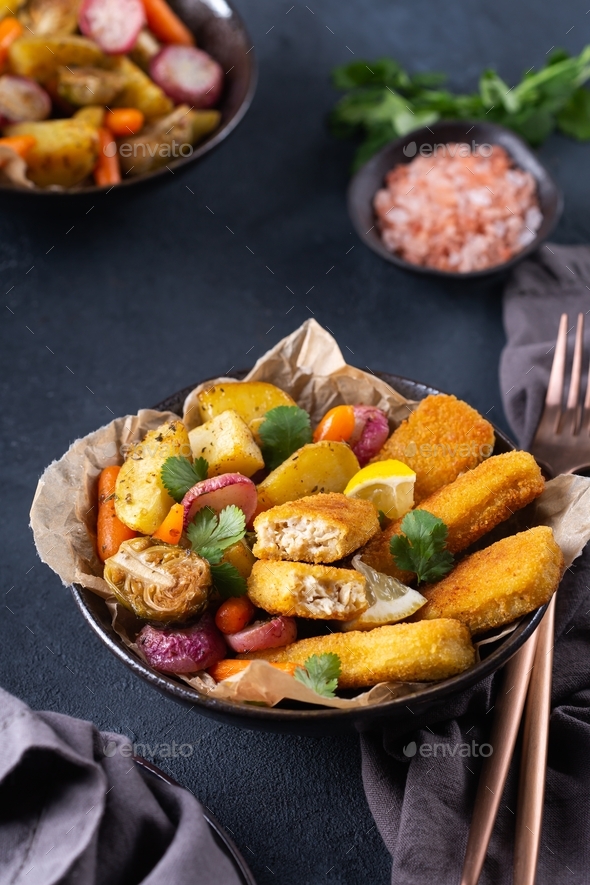Vegan Plant based fish, fishless fingers with roasted vegetables Stock ...