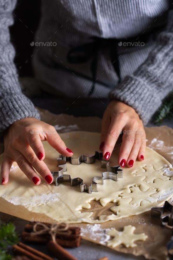 Christmas cooking and baking, female hands making cookies from dough ...