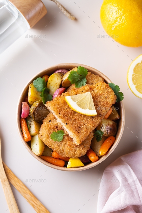 Vegan Plant based fish with crispy batter and roasted vegetables Stock ...