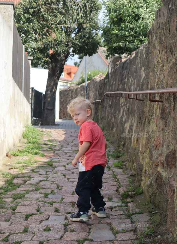 The little boy turns around warily to see if anyone is following him ...