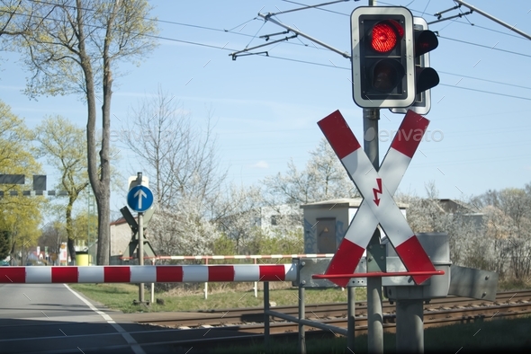 Level crossing with lowered barrier and traffic light Stock Photo by ...