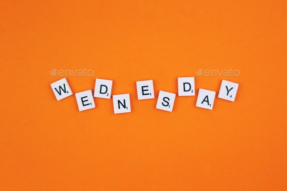 Wednesday scrabble letters word on a orange background Stock Photo by ...