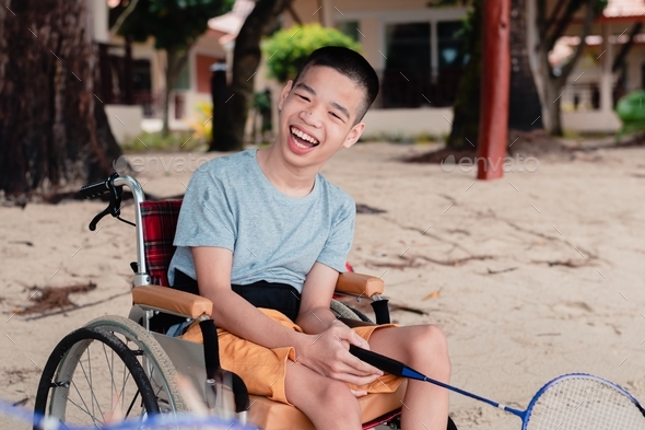 Disabled child on wheelchair smile holding badminton Stock Photo by ...