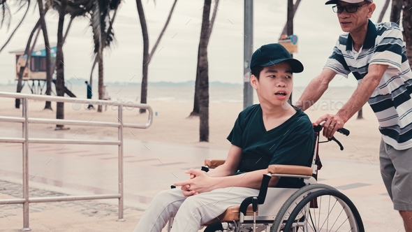 Disabled teenager boy on wheelchair and carer in public places. Stock ...