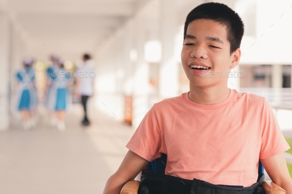 Confident handicapped teenager boy on wheelchair with happy face on ...