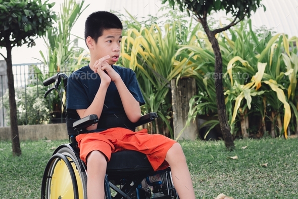 Handicapped boy on wheelchair worried face, the special children often ...