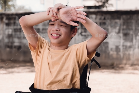 Happy disabled child on wheelchair smiling face with outdoors ...
