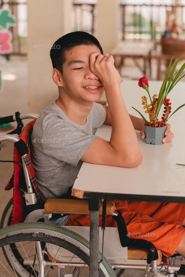 Smart handicapped teenager boy happy face with art of plant therapy in ...