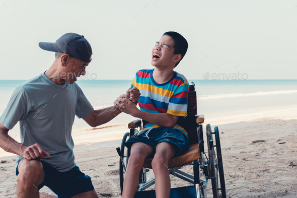 Disabled child on wheelchair and father having fun with exercise for ...