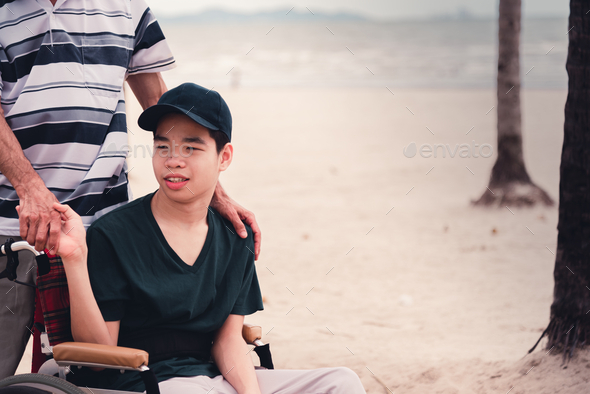 Disabled child on wheelchair with smile face holding parent’s hand on ...