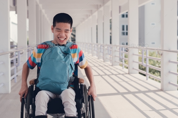 Disabled child on wheelchair with smile face on walking way in hospital ...