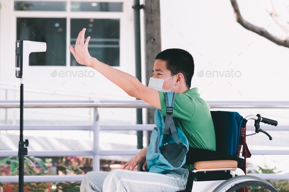 Young man with disability on wheelchair raise his hand to check body ...