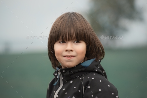 Child smiling face portrait on blurry background Stock Photo by breamchub