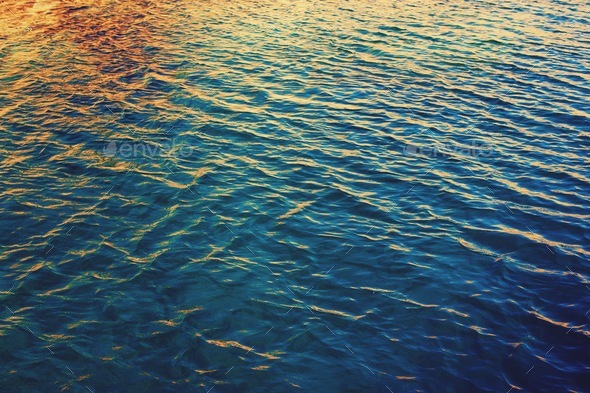 textured sea water background from azure and light blue sea depths with ...