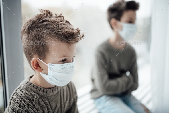 boys sit in self-isolation in masks in coronavirus lockdown Stock Photo ...