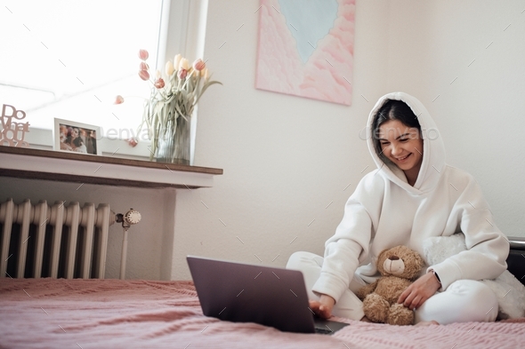 Smile candid authentic zoomer girl hug teddy bear using laptop for ...