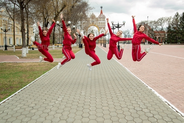 Girls in red tracksuits and white sneakers jumped high Stock Photo by ...