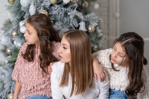 three sisters together looking in one direction with interest Stock ...
