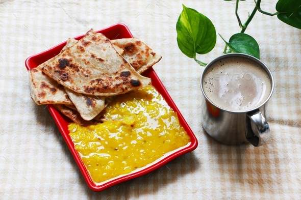 Roti Paratha with Dhal curry served with a cup of milk coffee Stock ...