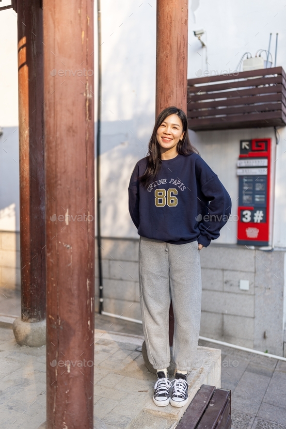 Happy stylish young asian generation z woman at fall season outdoor ...