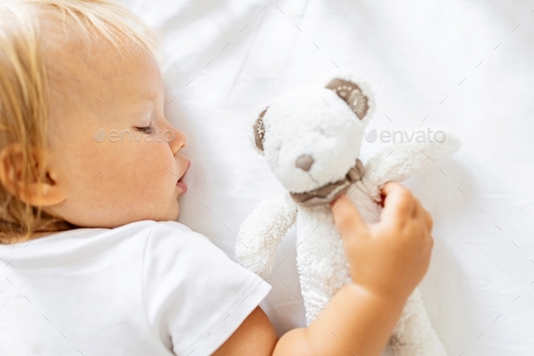 Cute little baby from behind wearing white clothing and sleeping on ...