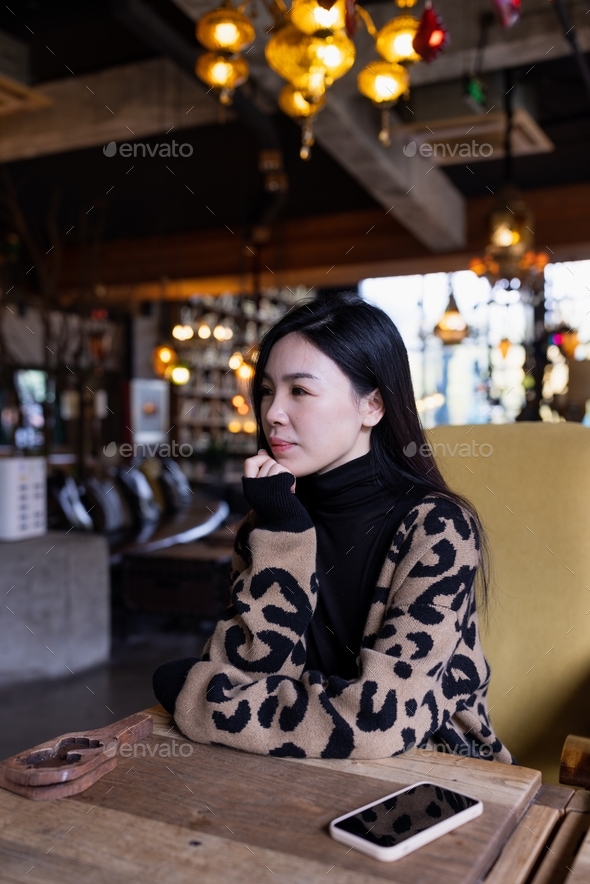 Happy stylish young asian generation z woman relaxing in small ...