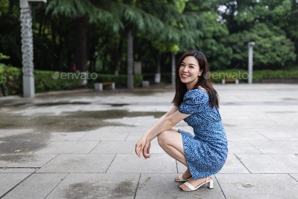 Candid portrait of attractive asian woman which walks in urban park in ...