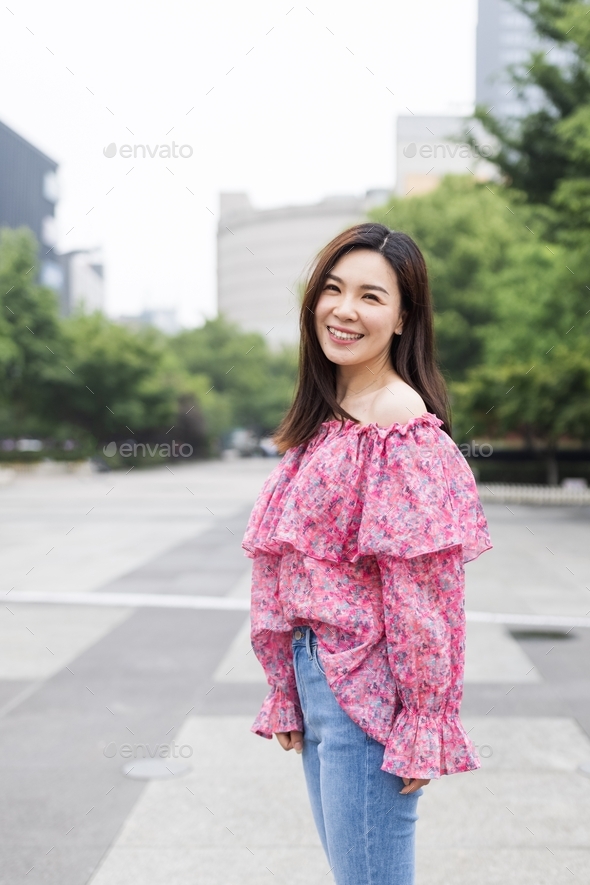 Candid portrait of attractive trendy asian woman which walks in urban ...