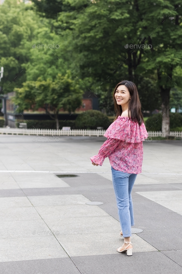 Candid portrait of attractive trendy asian woman which walks in urban ...