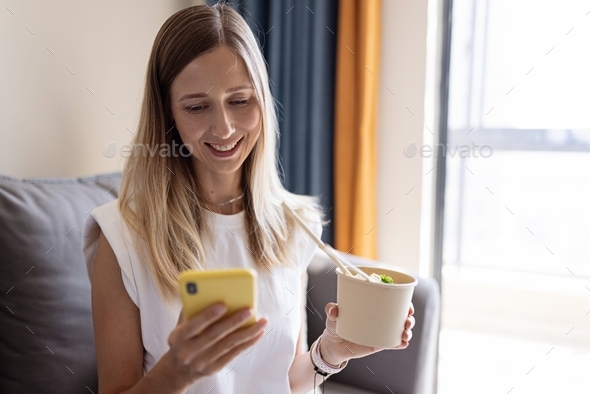 Happy Stylish girl eating from paper plate with healthy food for ...