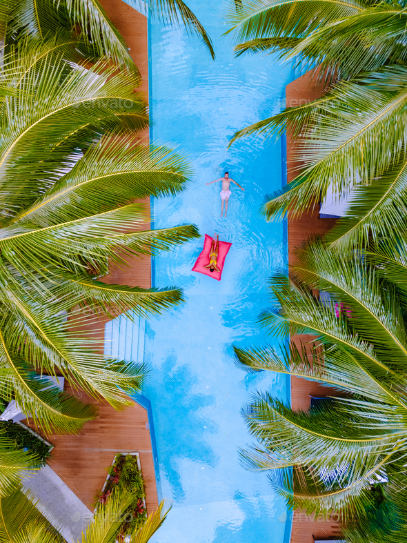 View from above at a swimming pool, couple men and women in swimming ...
