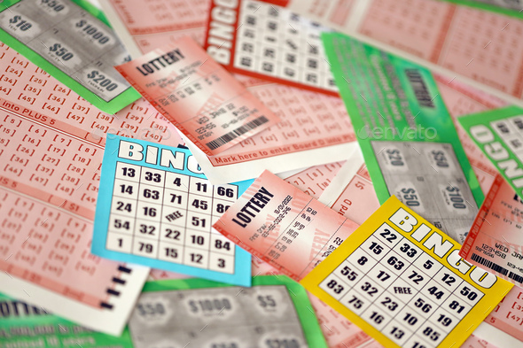 Many used lottery tickets, bills with numbers and bingo playing boards ...