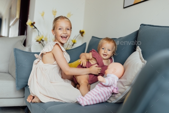 Happy caucasian siblings having fun when playing together at home on ...