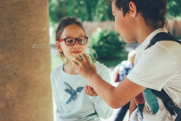 Two tweens girl and boy friends having fun near school Stock Photo by ...