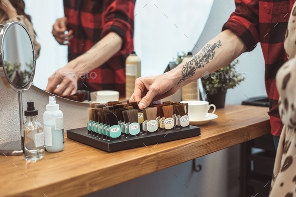 Stylist barber styling long hair for beautiful asian young woman in the ...