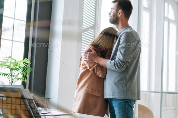 Young brunette woman with long hair in stylish suit crying with man in ...