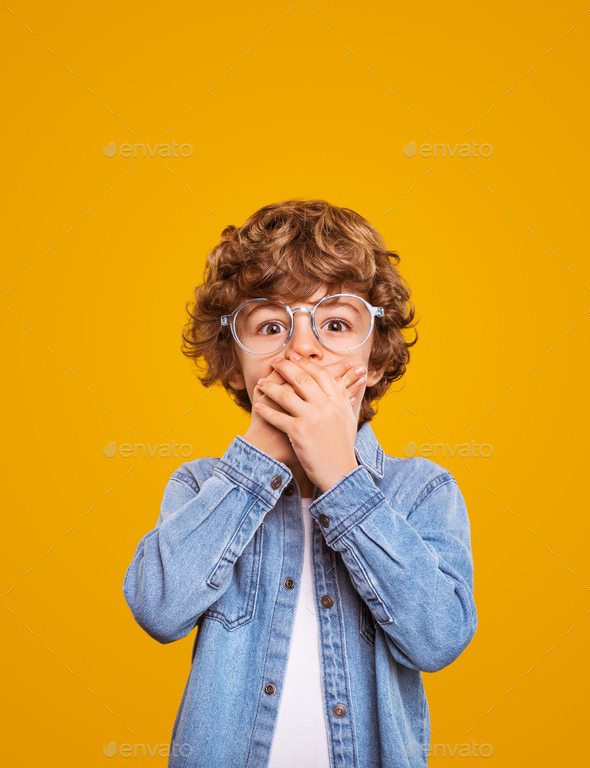 Shocked kid in glasses covering mouth Stock Photo by kegfire | PhotoDune
