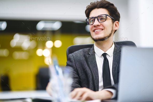 Young office manager working with papers and computer working at office ...
