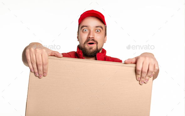 Amazed courier carrying heavy parcel Stock Photo by kegfire | PhotoDune