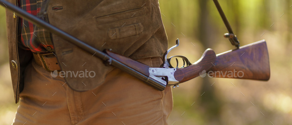 Close-up of hunter man carrying his rifle gun in forest. Stock Photo by ...