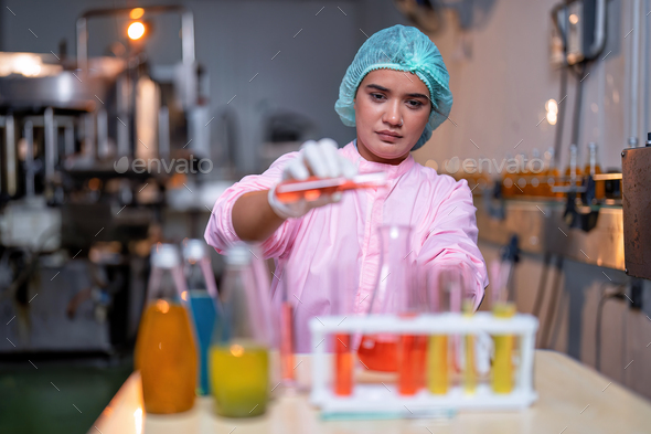 Beverage laboratory room worker in drink factory take product sample to ...