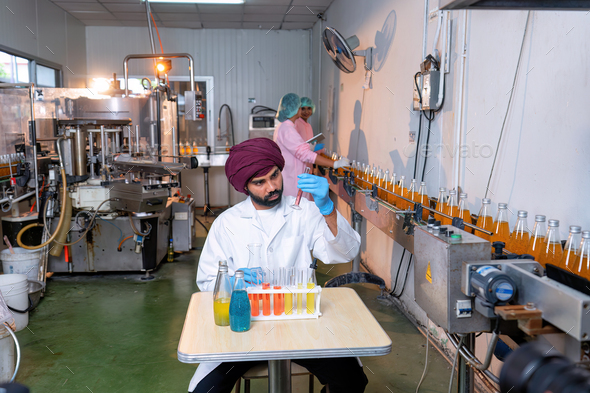 Beverage laboratory room worker in drink factory take product sample to ...