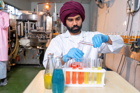 Beverage laboratory room worker in drink factory take product sample to ...