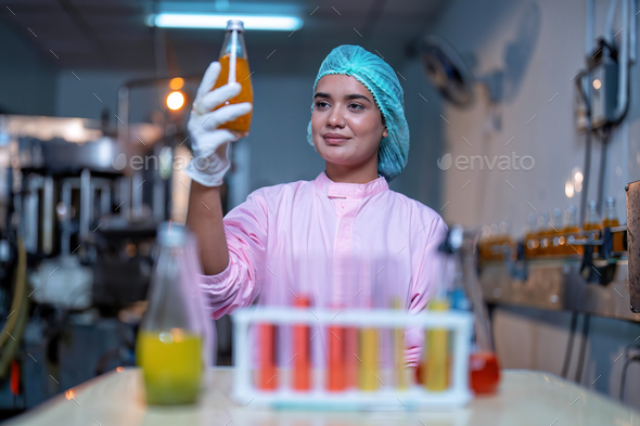 Beverage laboratory room worker in drink factory take product sample to ...