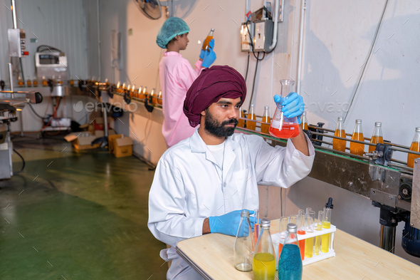 Beverage laboratory room worker in drink factory take product sample to ...