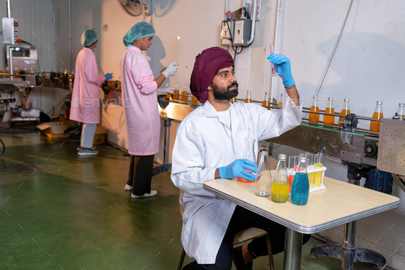 Beverage laboratory room worker in drink factory take product sample to ...