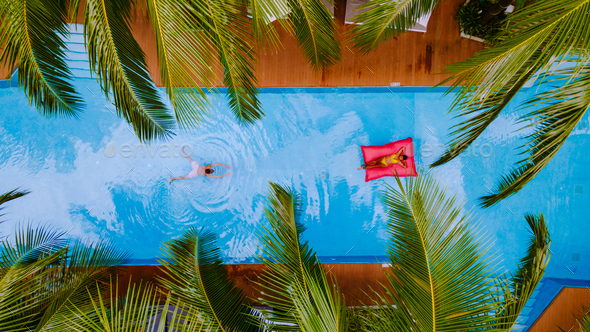 View from above at a swimming pool, couple men and women in swimming ...
